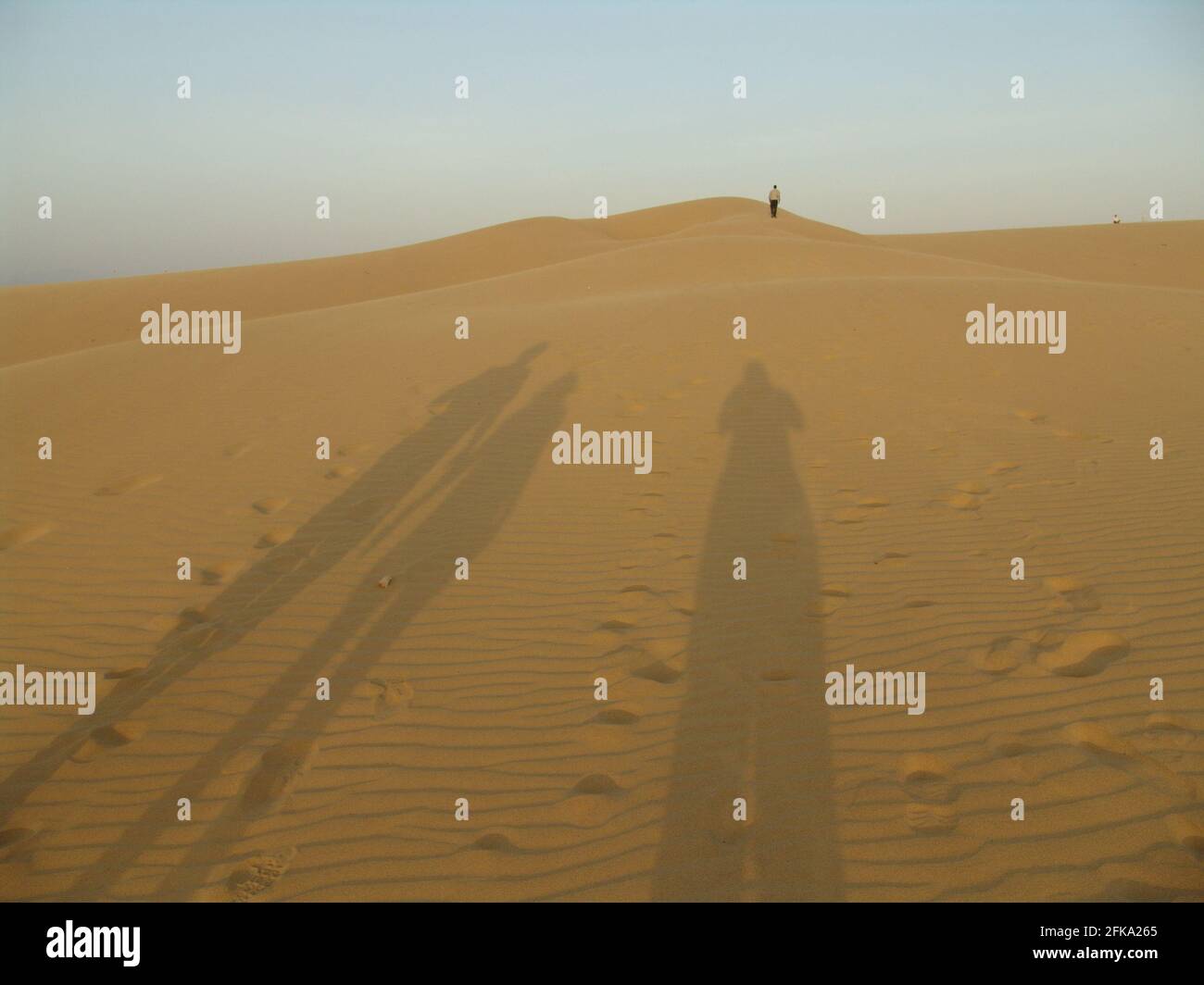 Creative shot of people's shadows on a sand desert Stock Photo - Alamy
