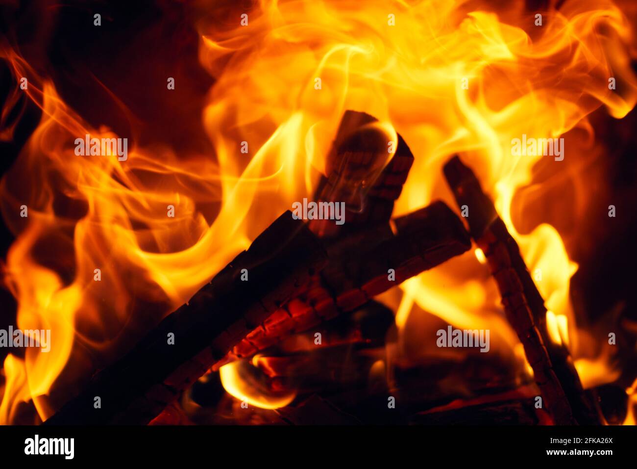 A fire burns in a fireplace, Fire to keep warm. Logs burning in a ...