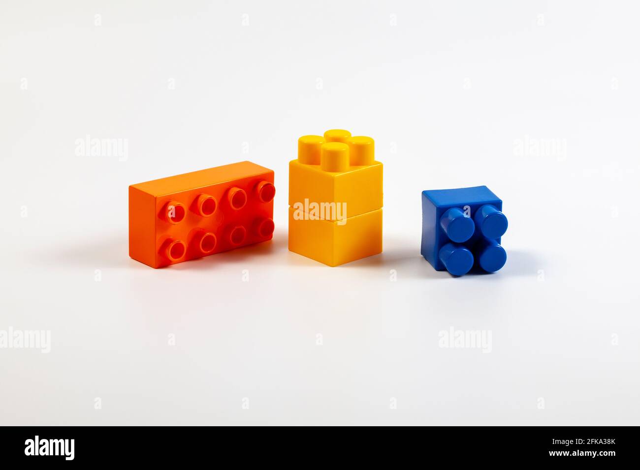 Multicolored blocks of the children's constructor lie on a white ...