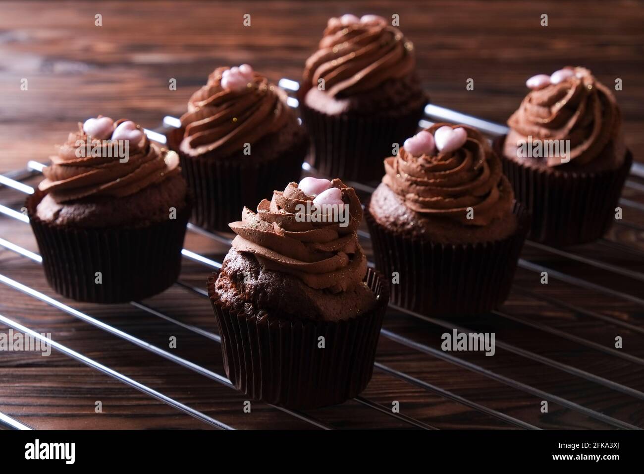 Delicious dark chocolate buttercup cupcakes, sugar heart topping ...