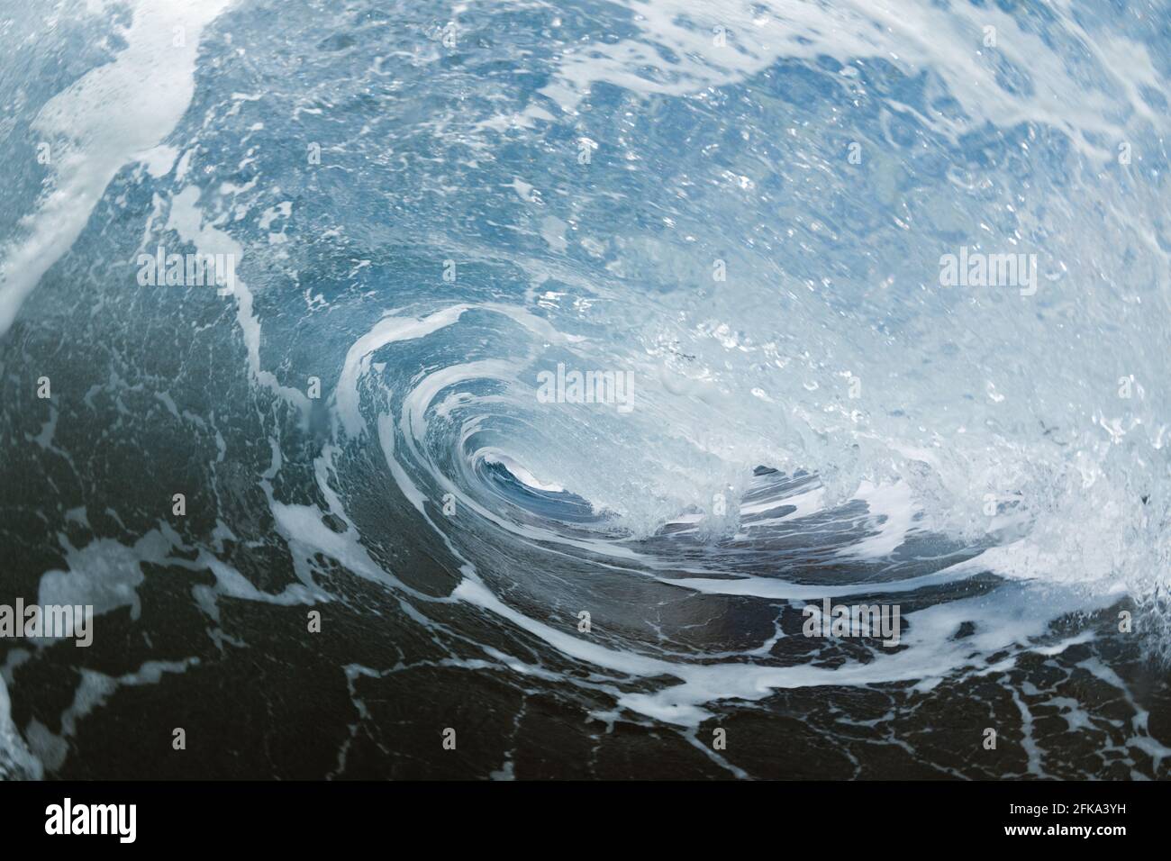 Inside a wave breaking on a beach Stock Photo - Alamy