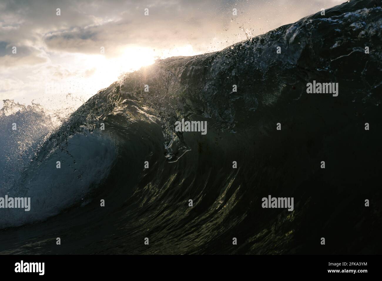 Wave breaking during sunset on a beach Stock Photo - Alamy