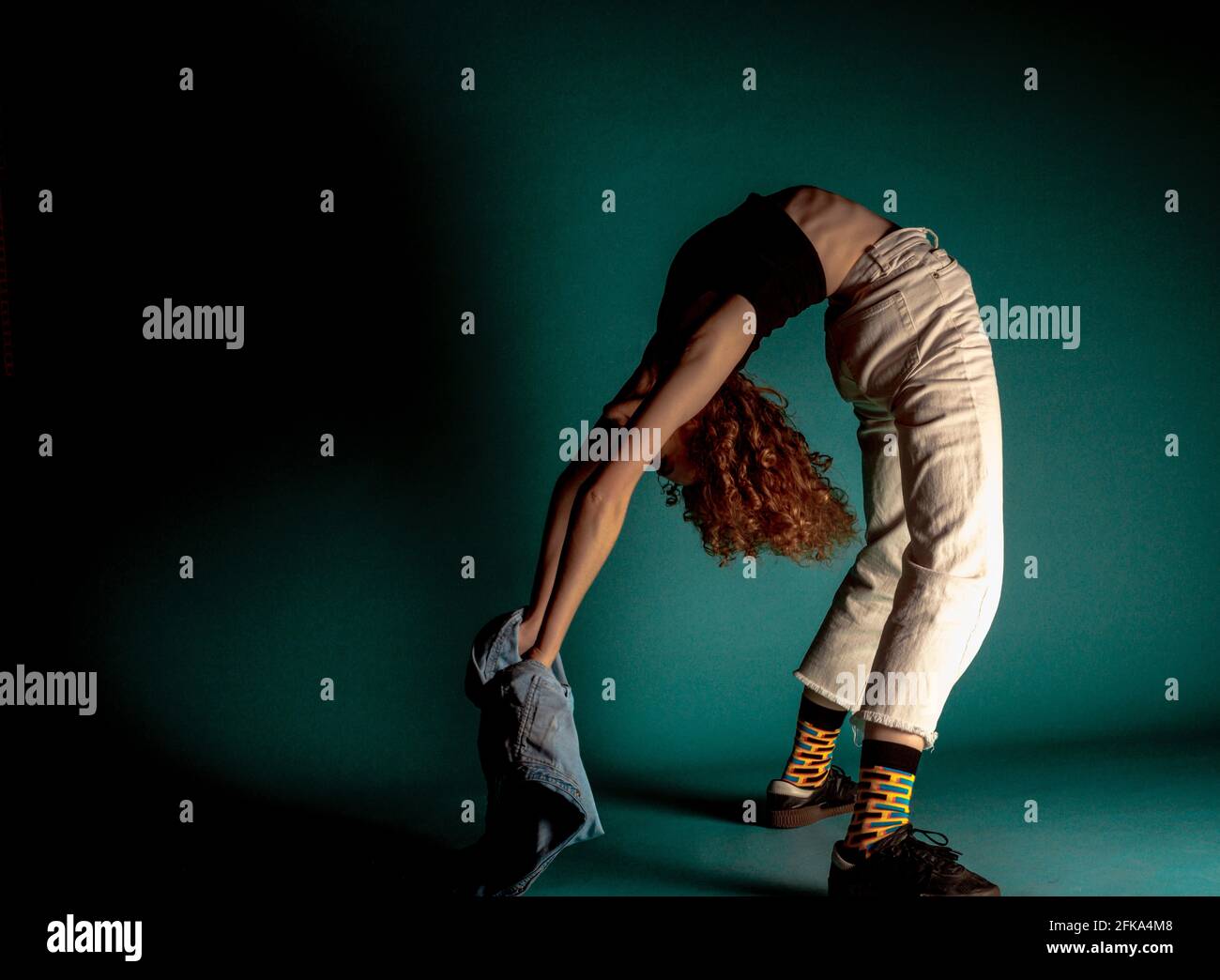 Slender flexible dance performer during a dance practice in modern ...