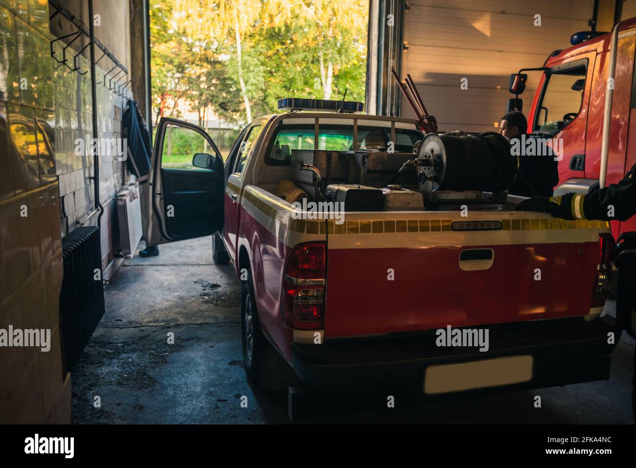 Fire engine truck parked inside the garage of the fire department Stock ...
