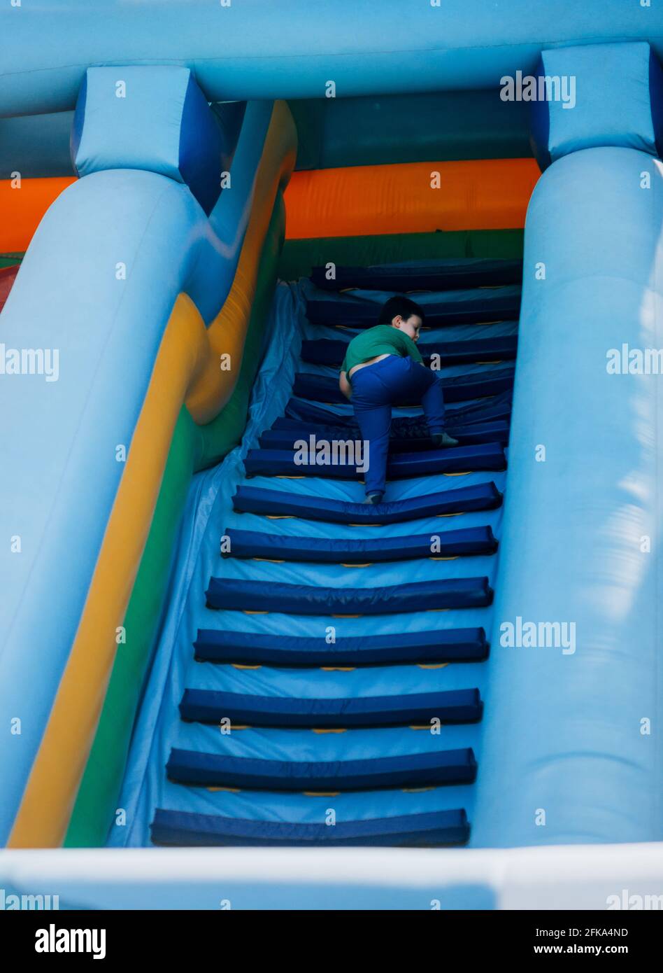 Beautiful boy having fun on the amusement attractions at the local ...