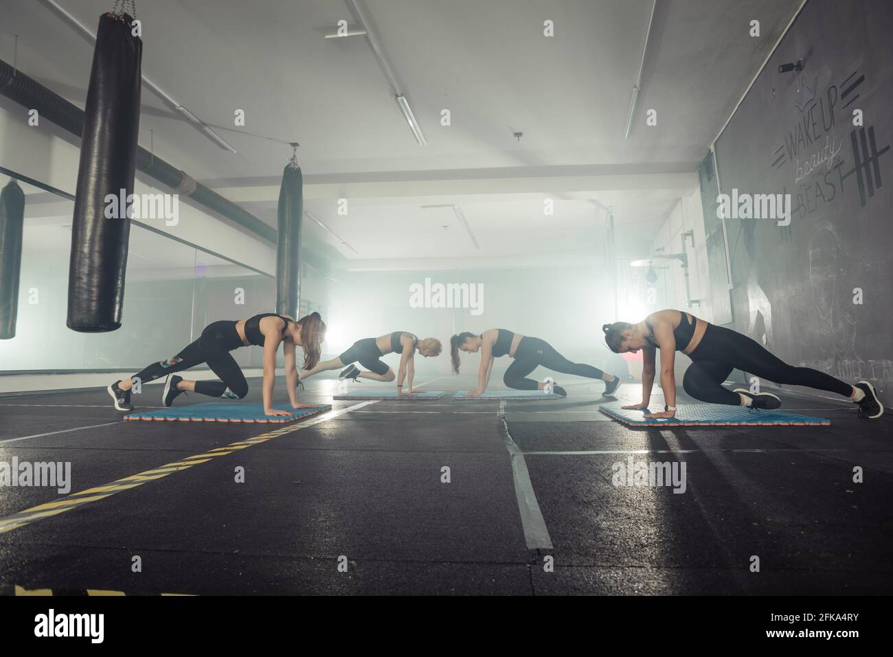 Women in black and white sportswear on a real group body Combat workout ...