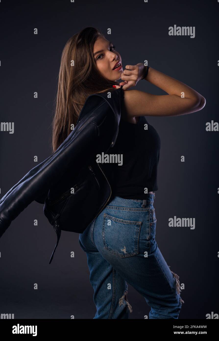 Portrait of a beautiful female model wearing black boots and skirt ...