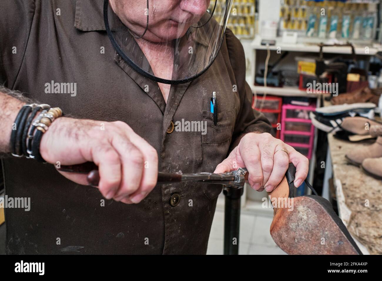 Shoemaker working in a workshop Stock Photo - Alamy