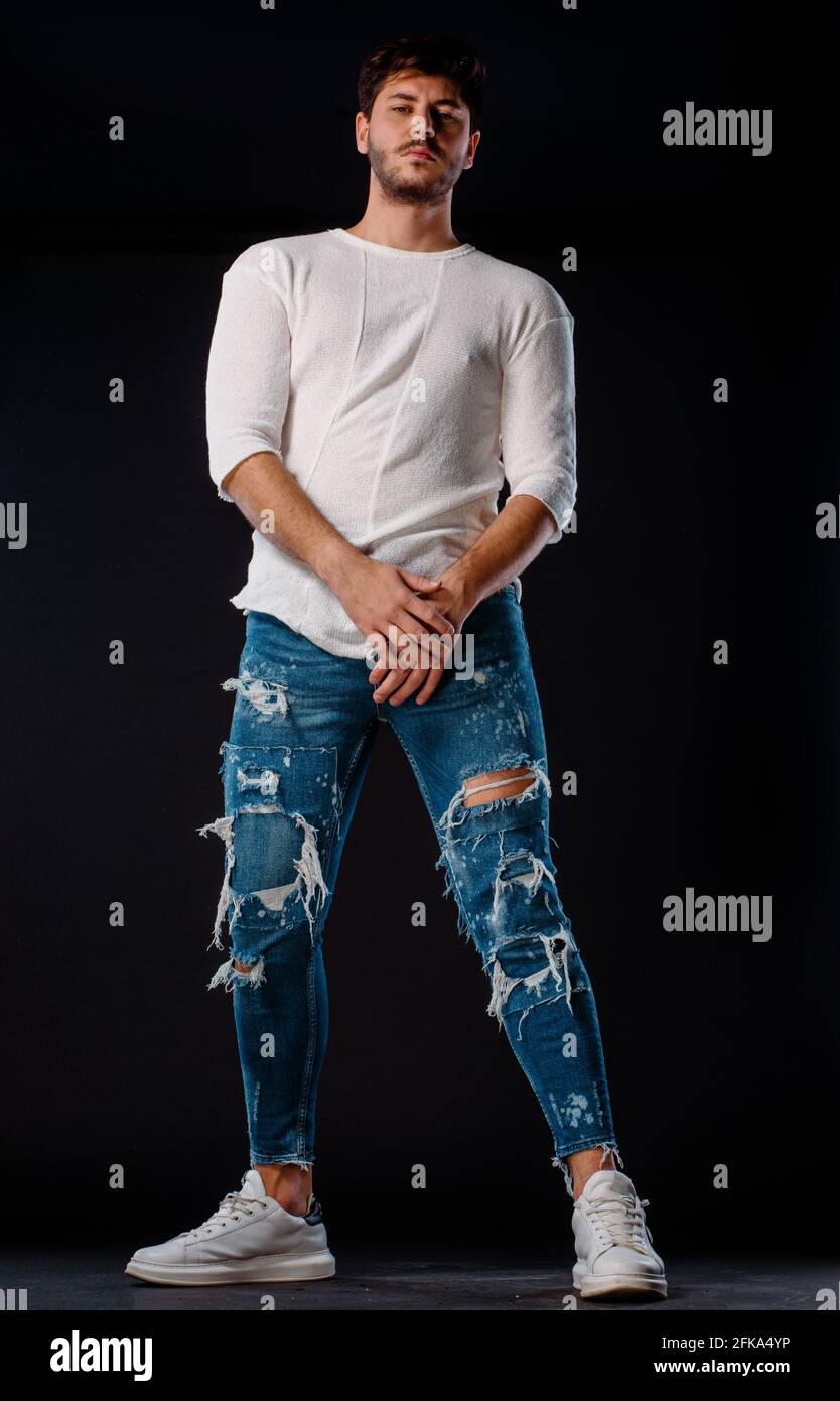 Portrait of a handsome stylish man posing in trendy modern clothing ...
