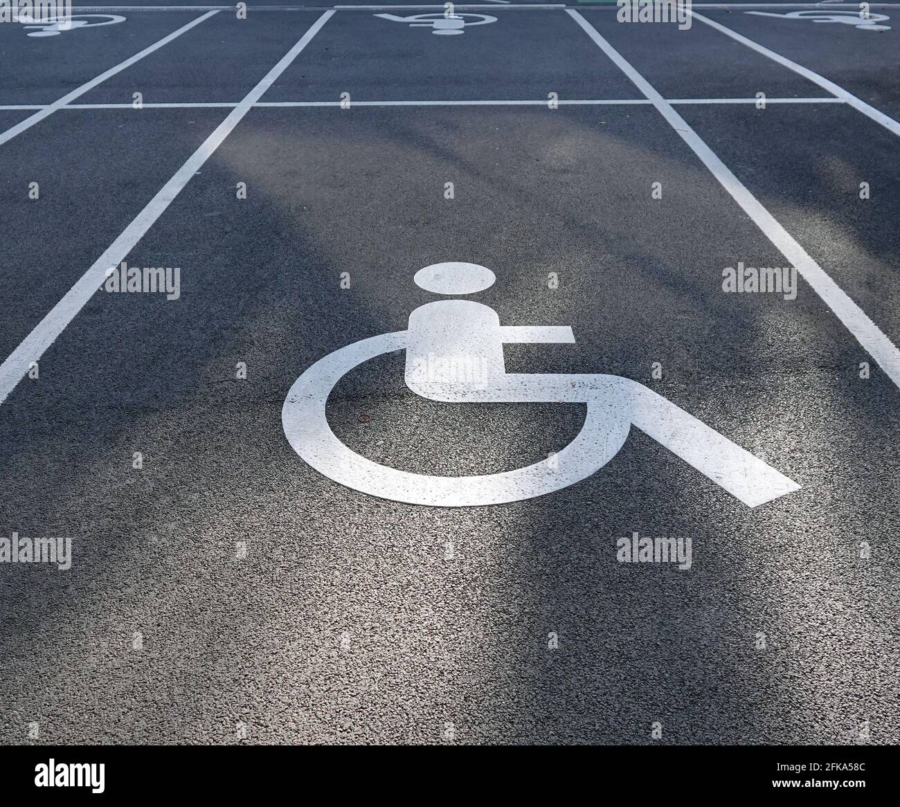 Handicap sign on the ground in a parking lot Stock Photo - Alamy