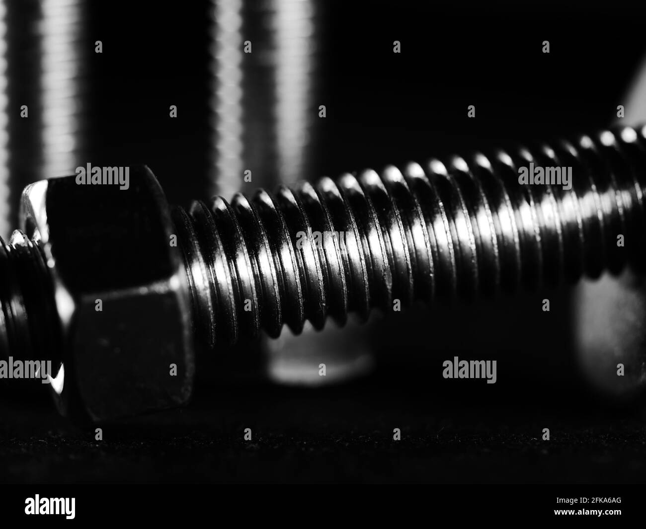 Closeup shot of metal screw threads isolated on the black background ...
