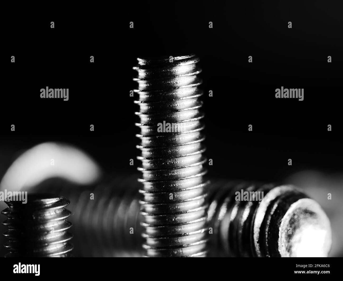 Closeup shot of metal screw threads isolated on the black background ...