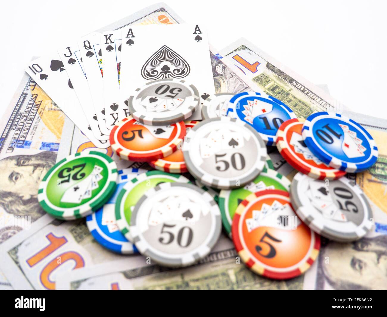 Deck of cards and poker chips on dollar banknotes isolated on a white ...