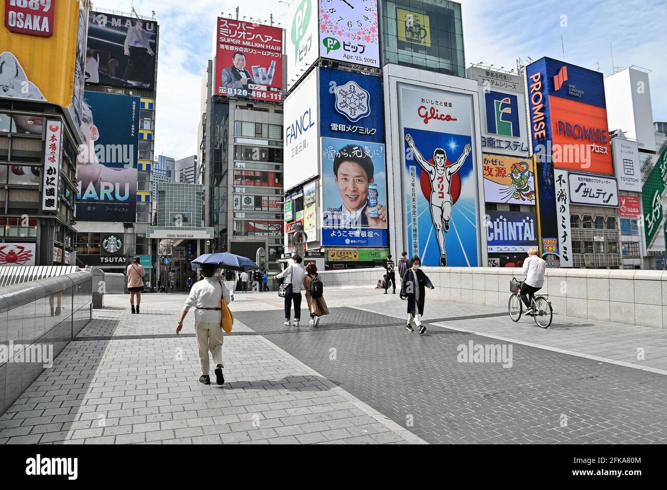 Pedestrians wearing face masks walk in Dotonbori shopping quarters in ...