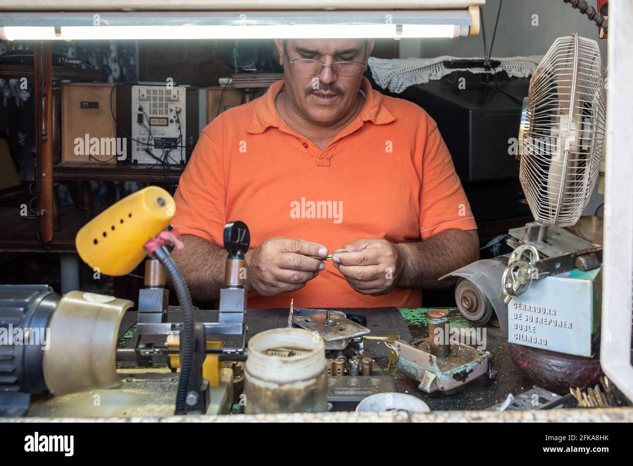 Locksmith working in his desk. The beginning of small private ...