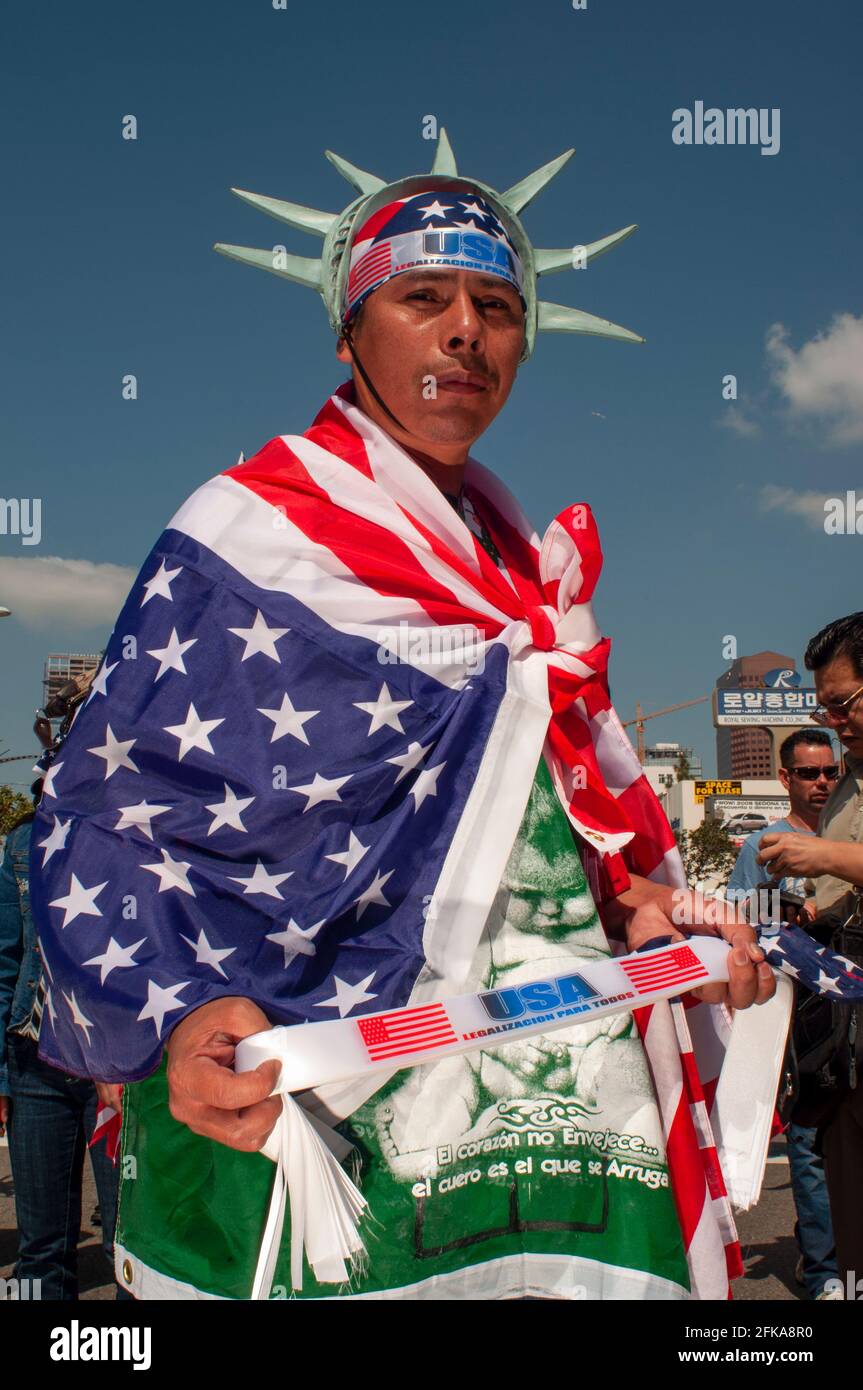 A patriotic man with American flags and a Lady Liberty crown poses for ...
