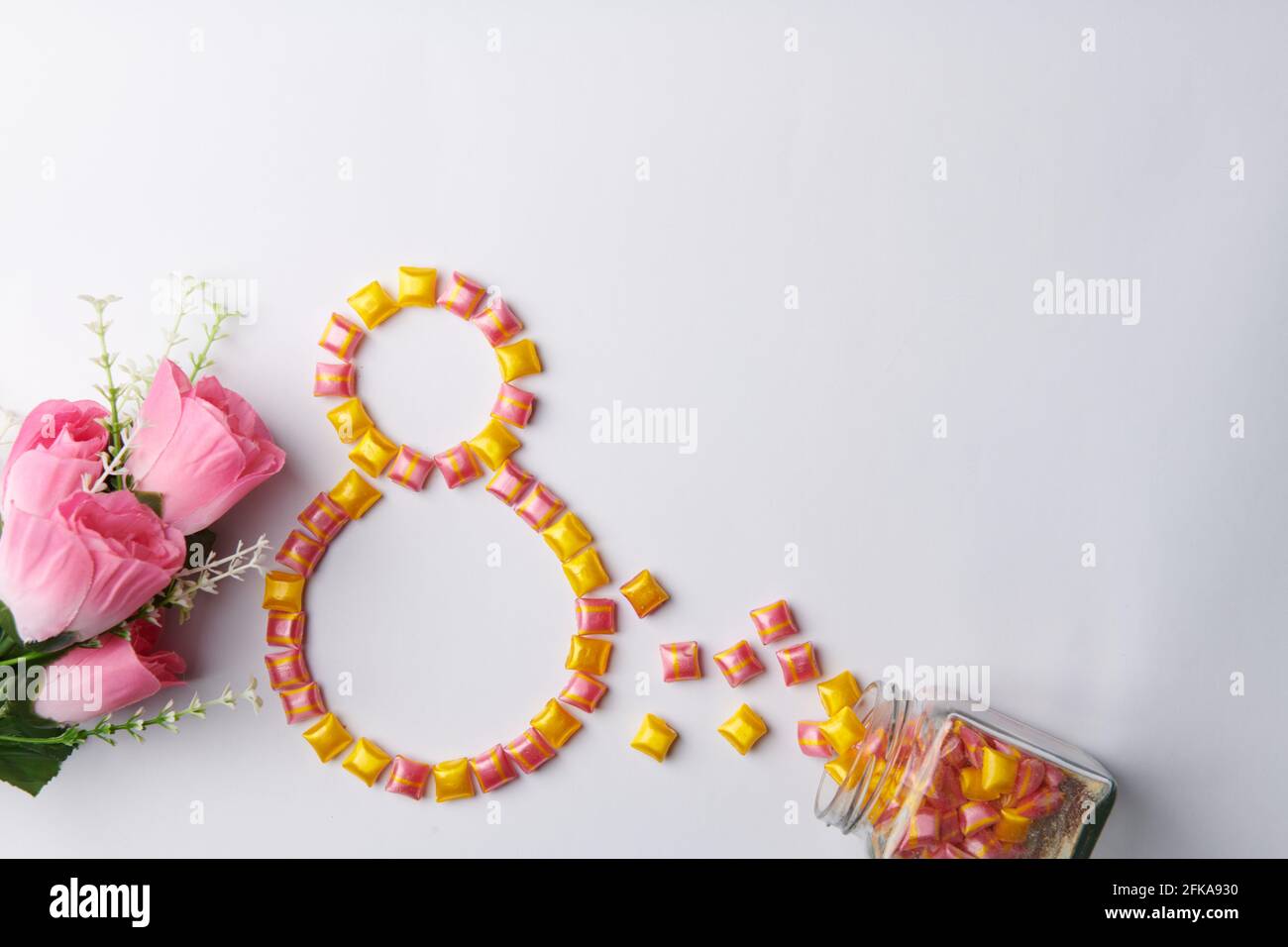 on a white background a jar of candies scattered number eight made ...