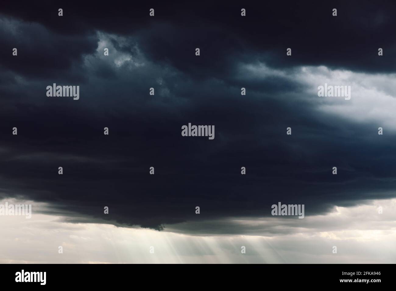 Black clouds with sun rays . Stormy weather with cloudburst Stock Photo ...