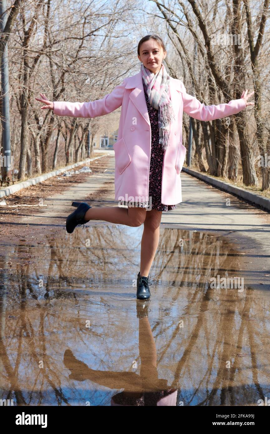 girl dancing on a puddle with trees reflection Stock Photo - Alamy