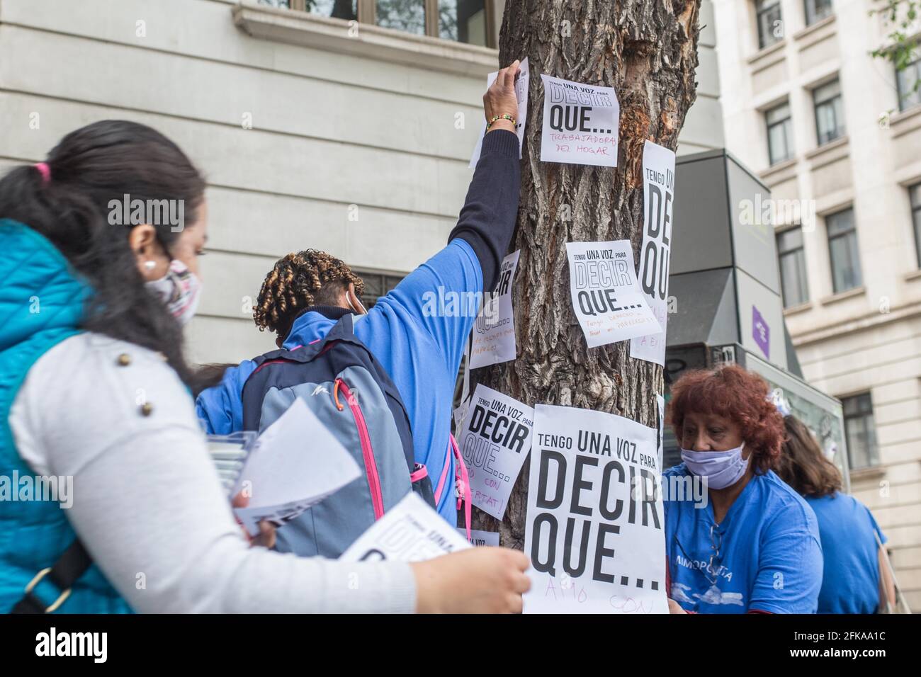 Protesters seen putting up posters on a tree in front of the National ...