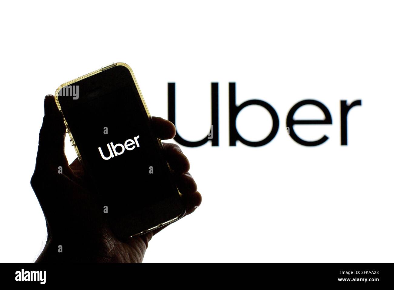 In this photo illustration a Uber logo seen displayed on a smartphone ...