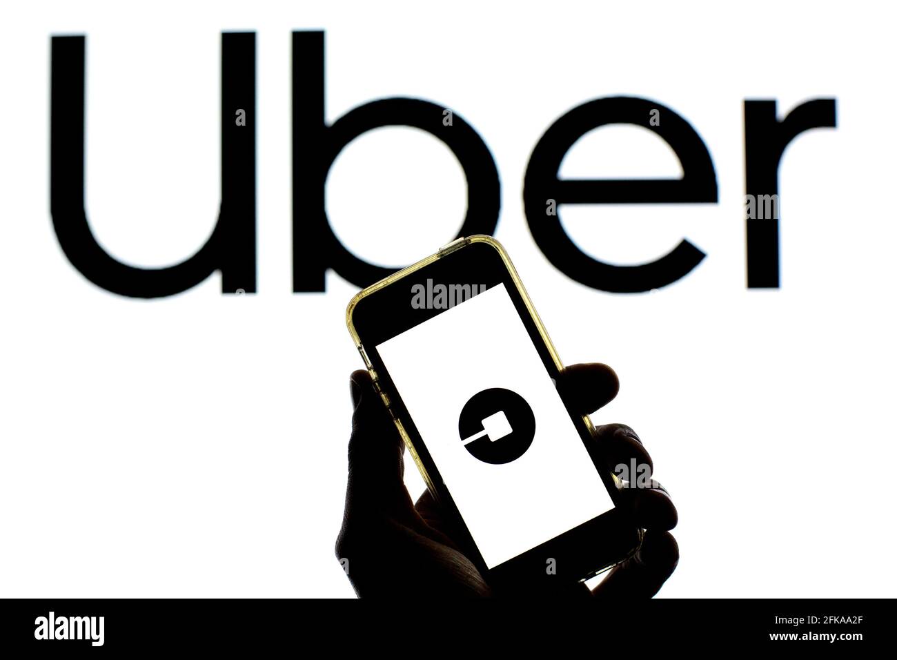 In this photo illustration a Uber logo seen displayed on a smartphone ...
