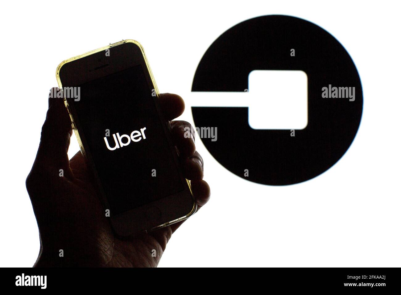 In this photo illustration a Uber logo seen displayed on a smartphone ...