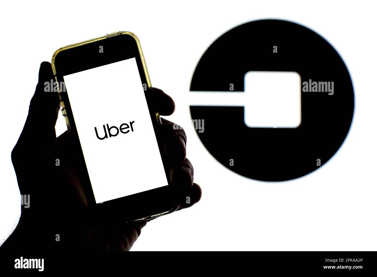 In this photo illustration a Uber logo seen displayed on a smartphone ...