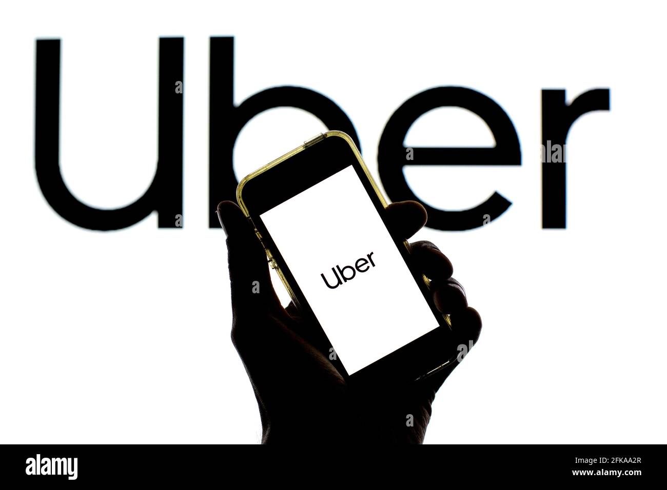 In this photo illustration a Uber logo seen displayed on a smartphone ...
