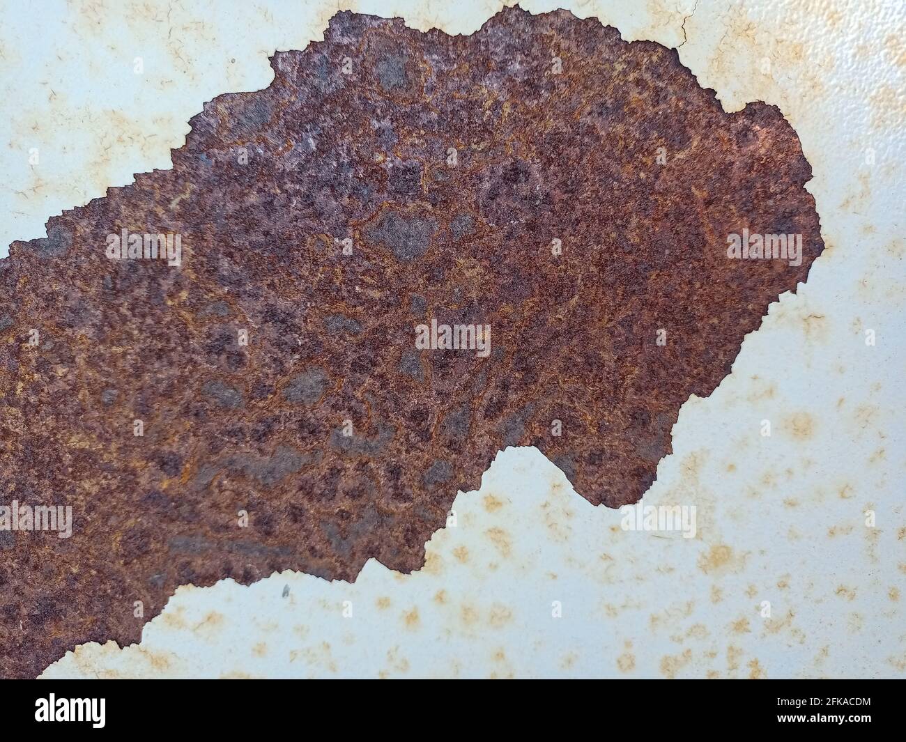 Old paint is cracking. Rust appeared from under the paint. Corrosion ...