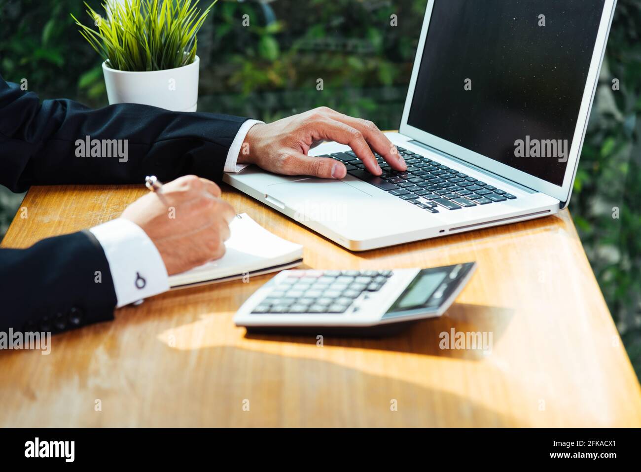 Business man accounting using calculating and work with laptop computer ...