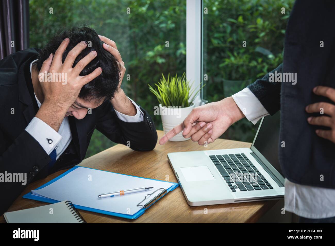 Businessman boss angry scolding ineffective point at employee at office ...