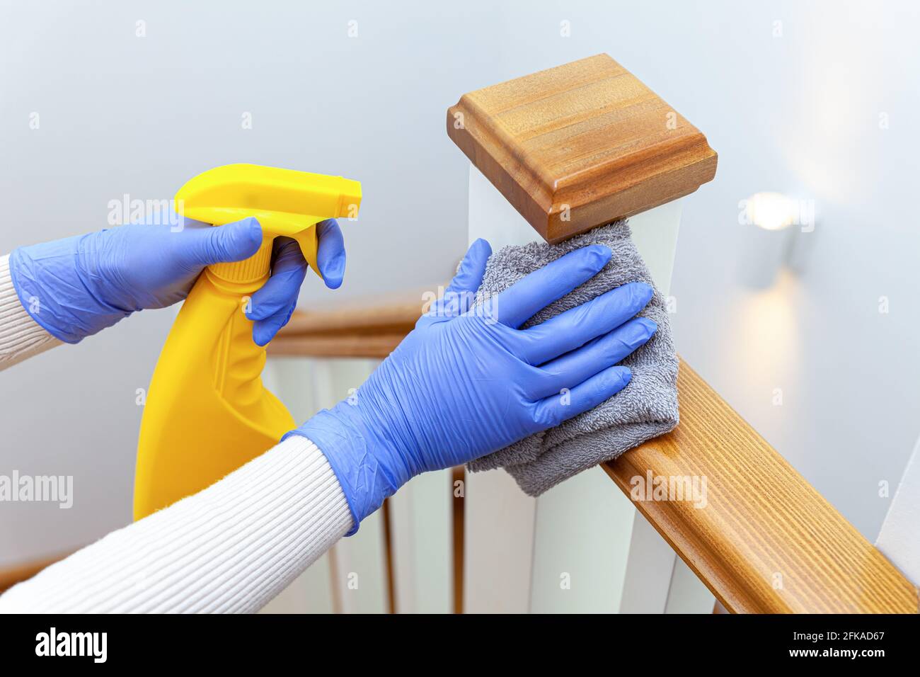 Woman hands in gloves cleaning stairs railings with rag Stock Photo - Alamy