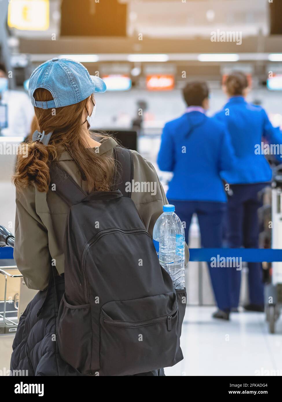 Back view of airline passenger wear face mask to prevent Corona virus ...