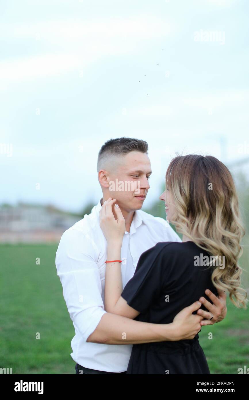 Portrait of american man hugging back view girl on football field Stock ...
