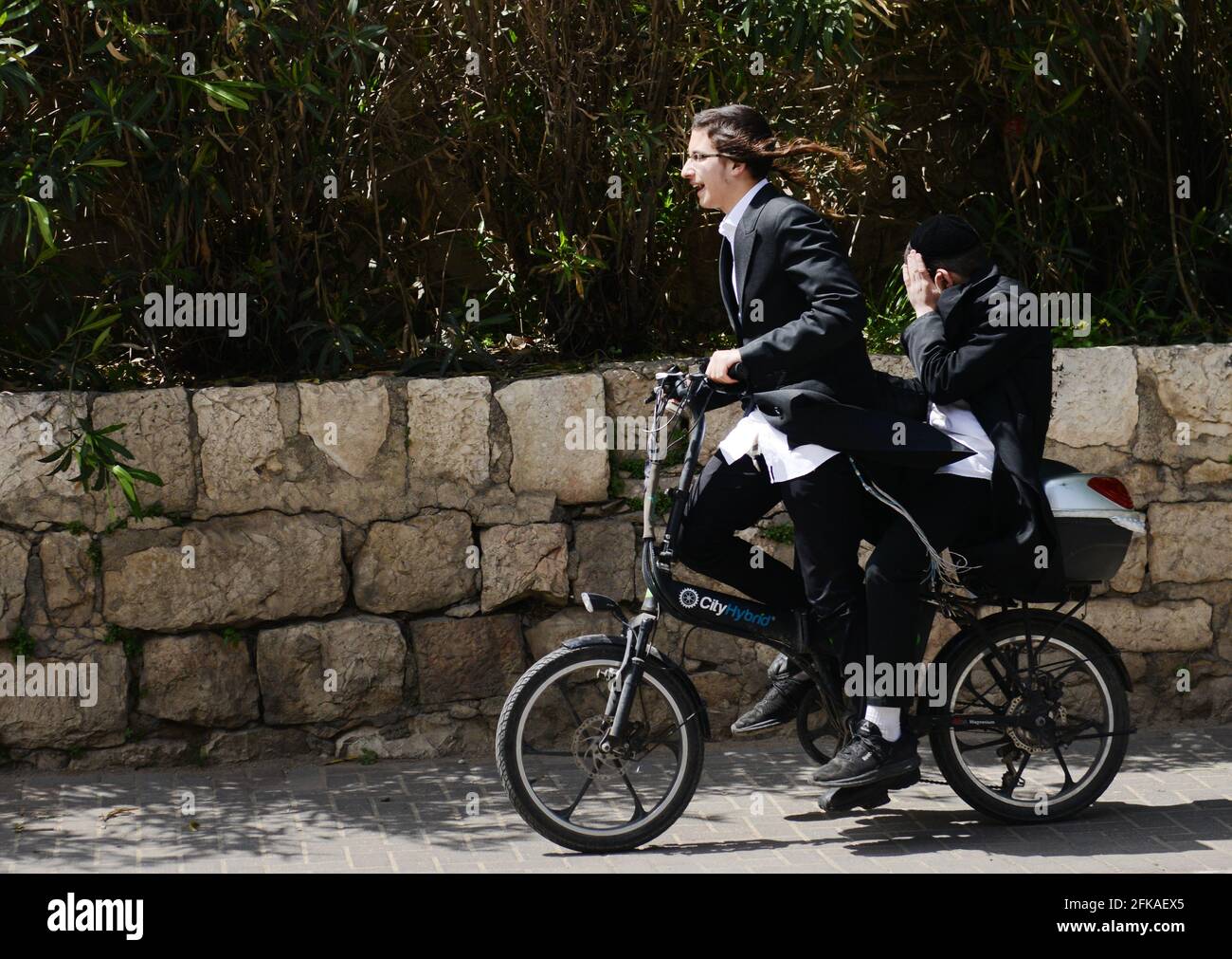 Jewish Yeshiva boys riding his bicycle in Jerusalem, Israel Stock Photo ...