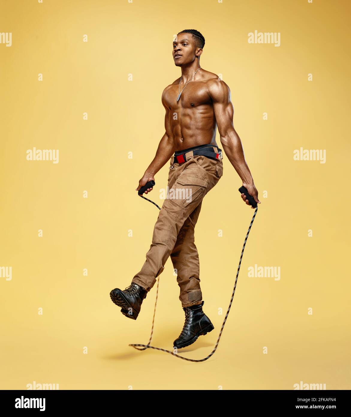 Handsome young man training with skipping rope. Photo of sporty ...