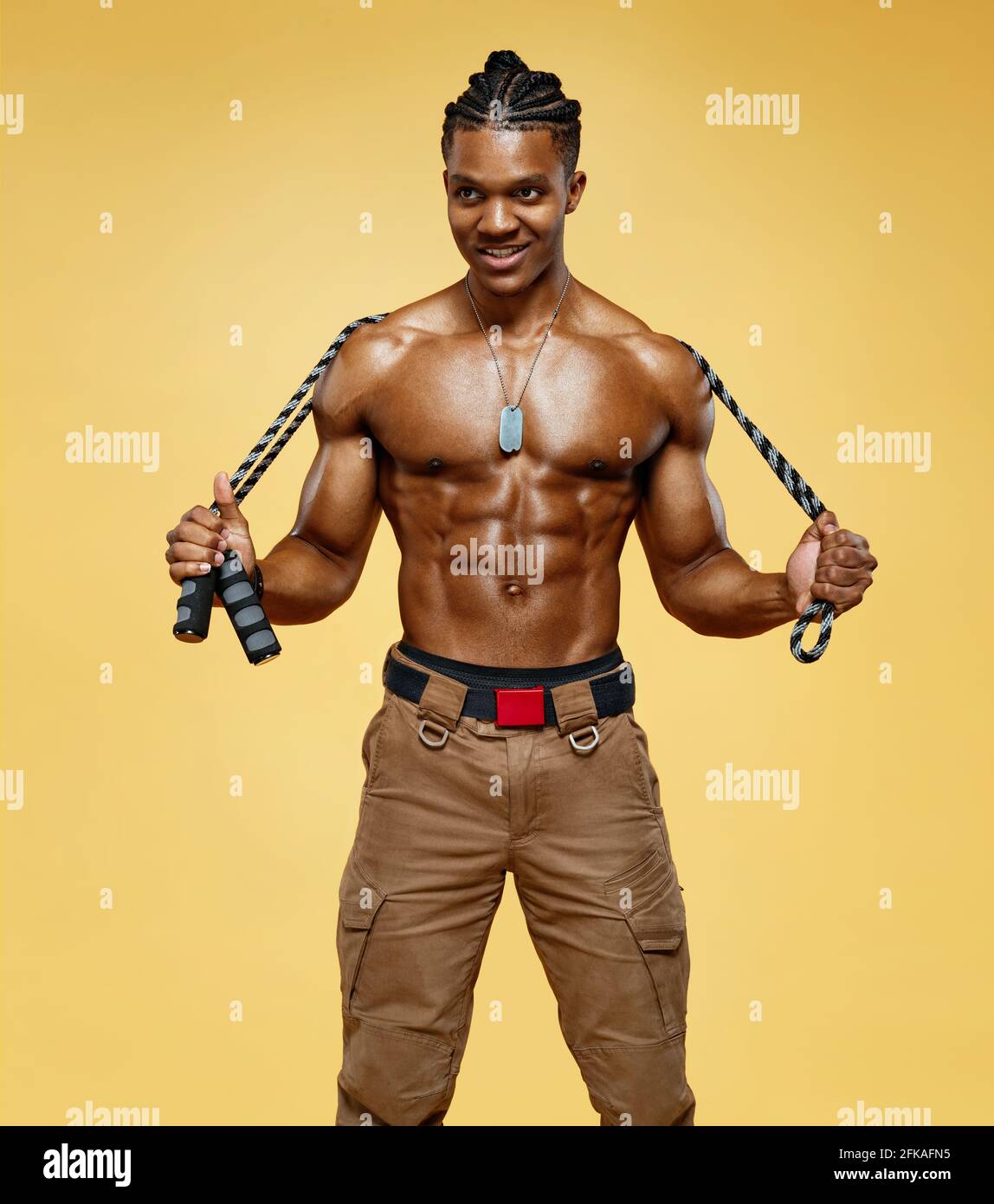 Smiling man with a skipping rope on shoulders. Photo of sporty muscular ...