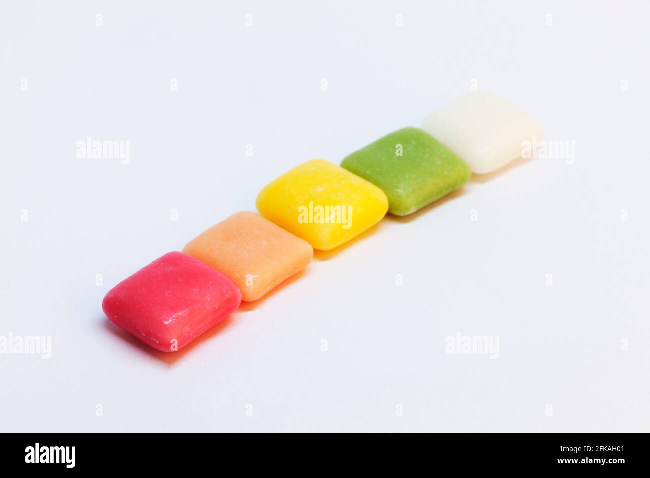 chewy candy in the colors of the rainbow on a white background Stock ...