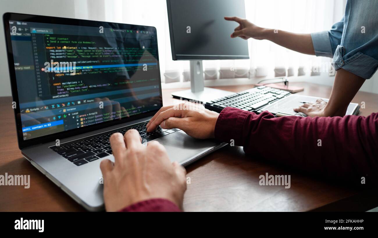 Team of Programmer working to find solution to problem and coding technologies in a software ...