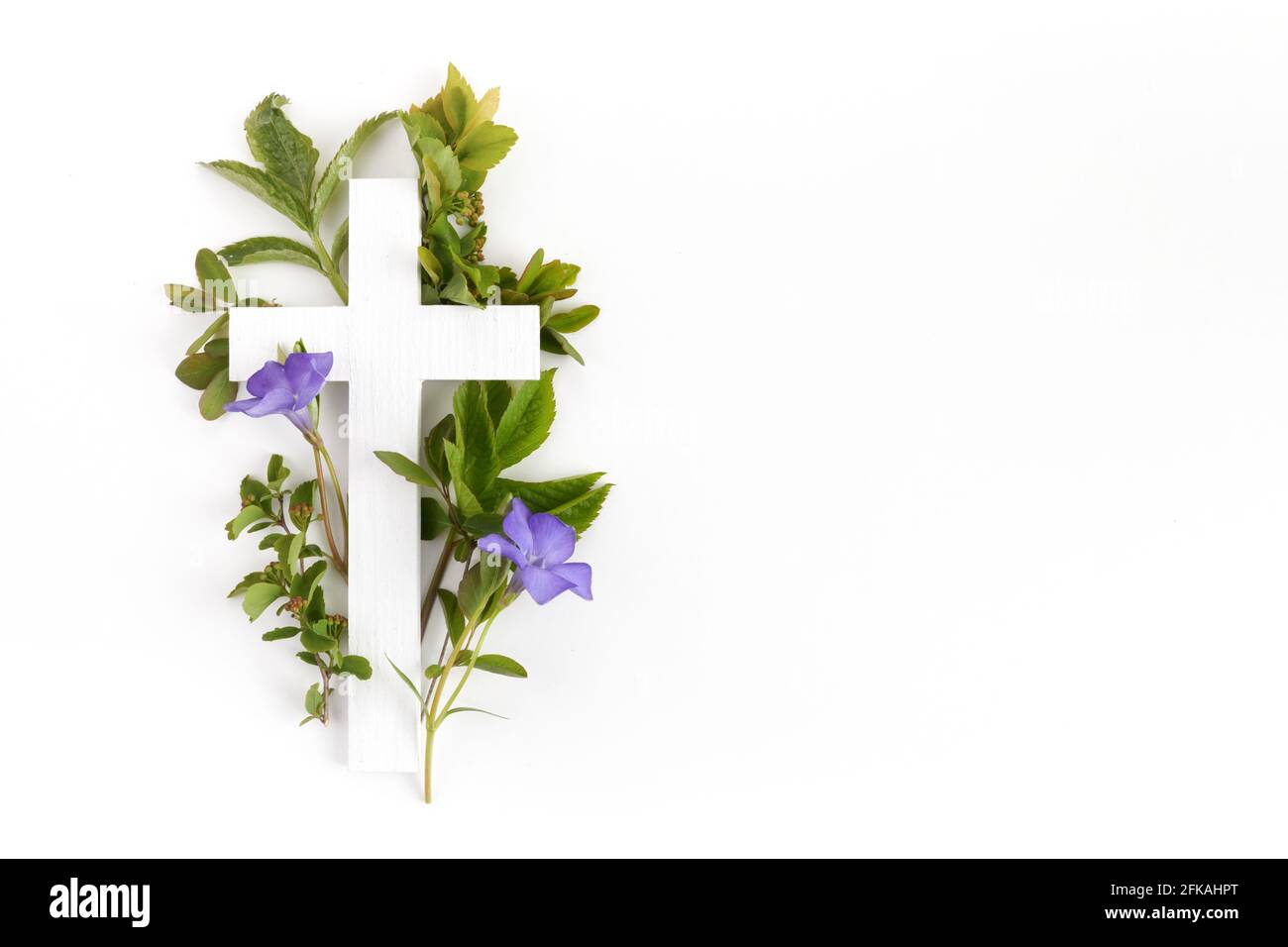 The Christianity cross of green leaves. Baptism, Easter, church holiday ...