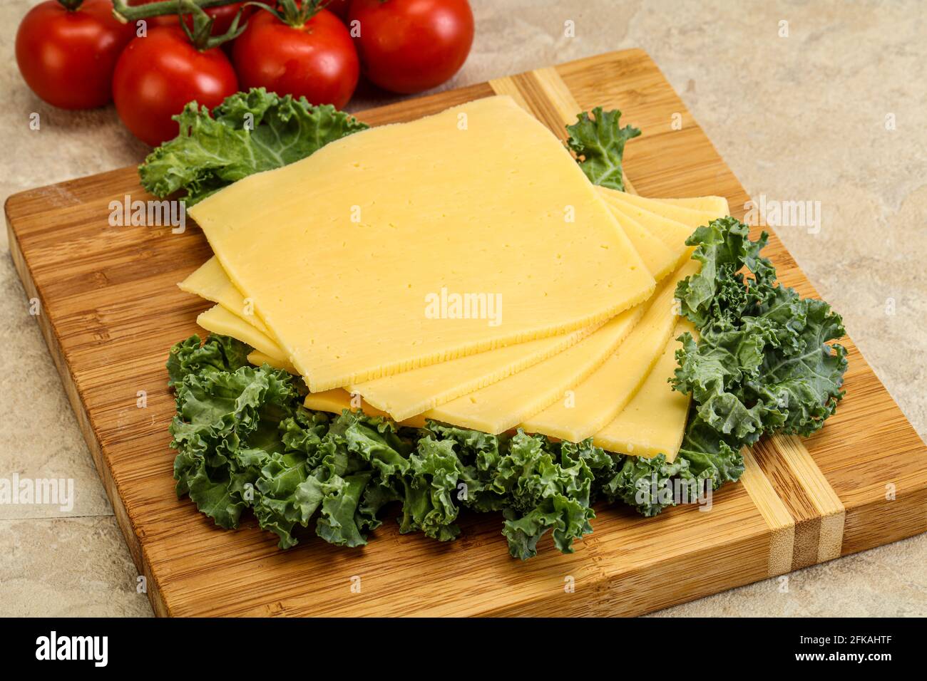 Sliced Gauda cheese snack over board Stock Photo - Alamy