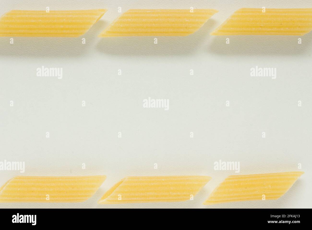 Penne noodles as a frame on white background with copy space Stock ...