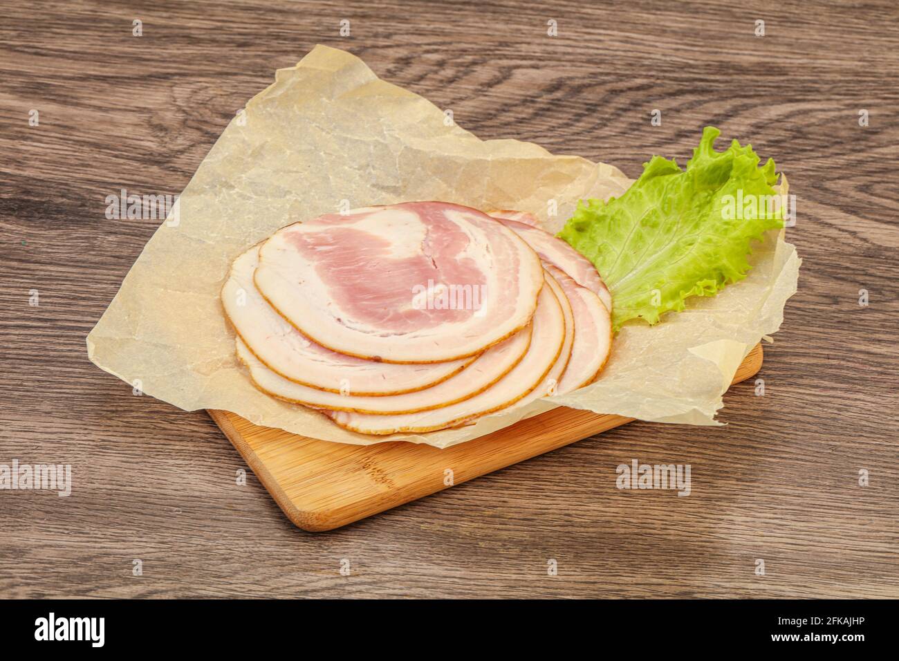 Sliced Italian Pancetta sausage over board Stock Photo - Alamy