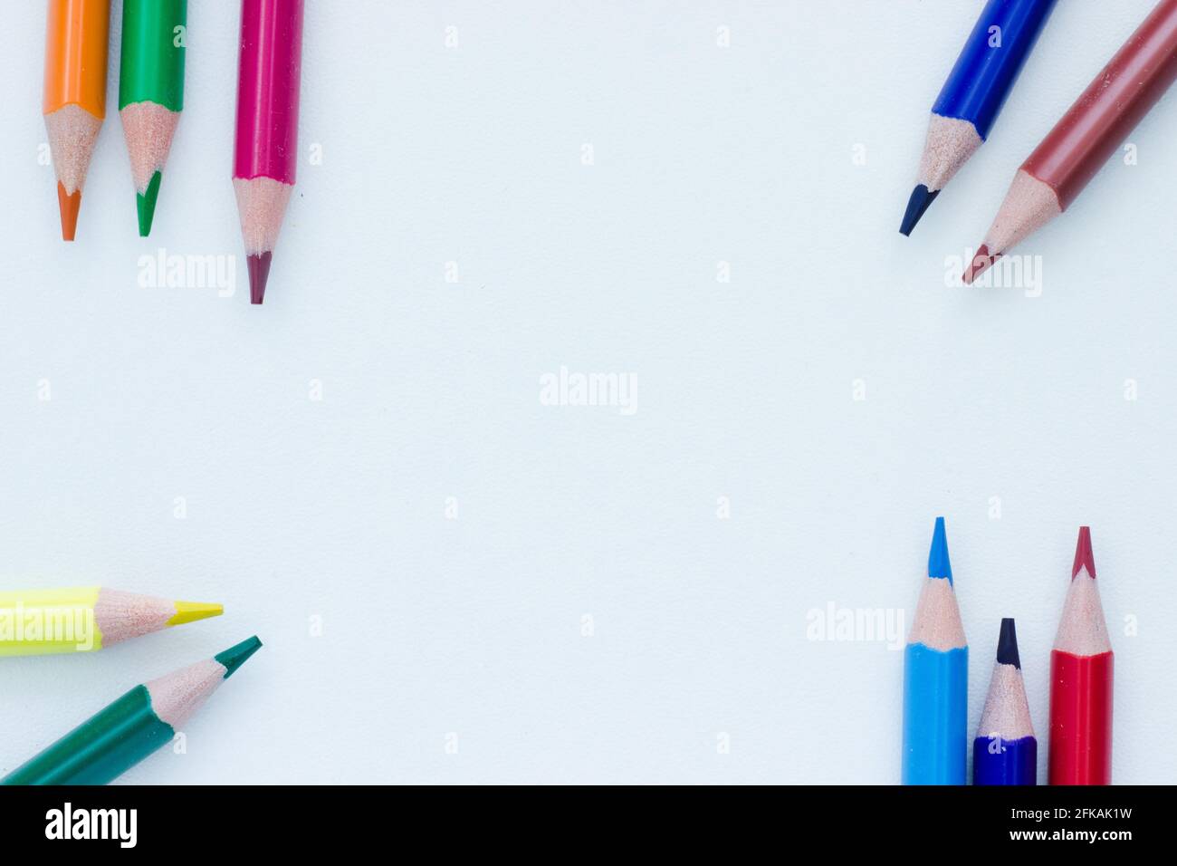Rainbow colored sharp pencils on white background pointing in one ...