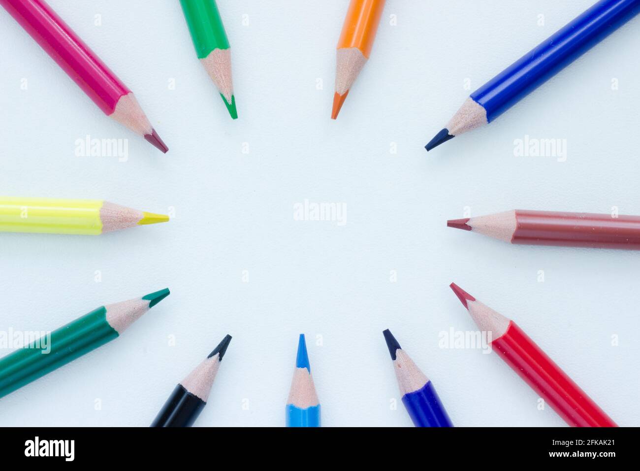 Rainbow colored sharp pencils on white background pointing in one ...