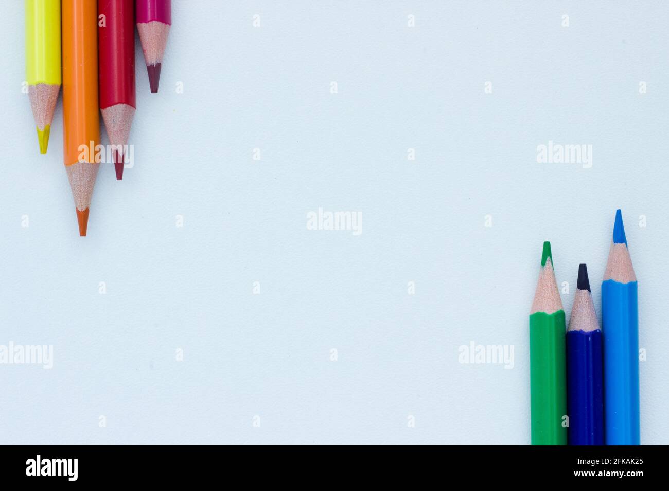 Rainbow colored sharp pencils on white background pointing in one ...