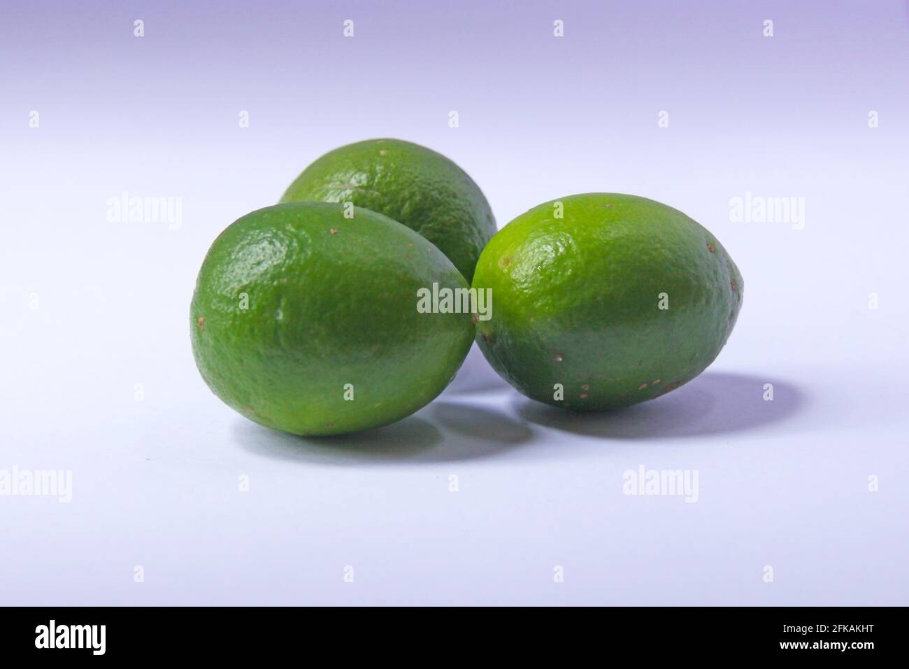 fresh green lemon on a white background Stock Photo - Alamy