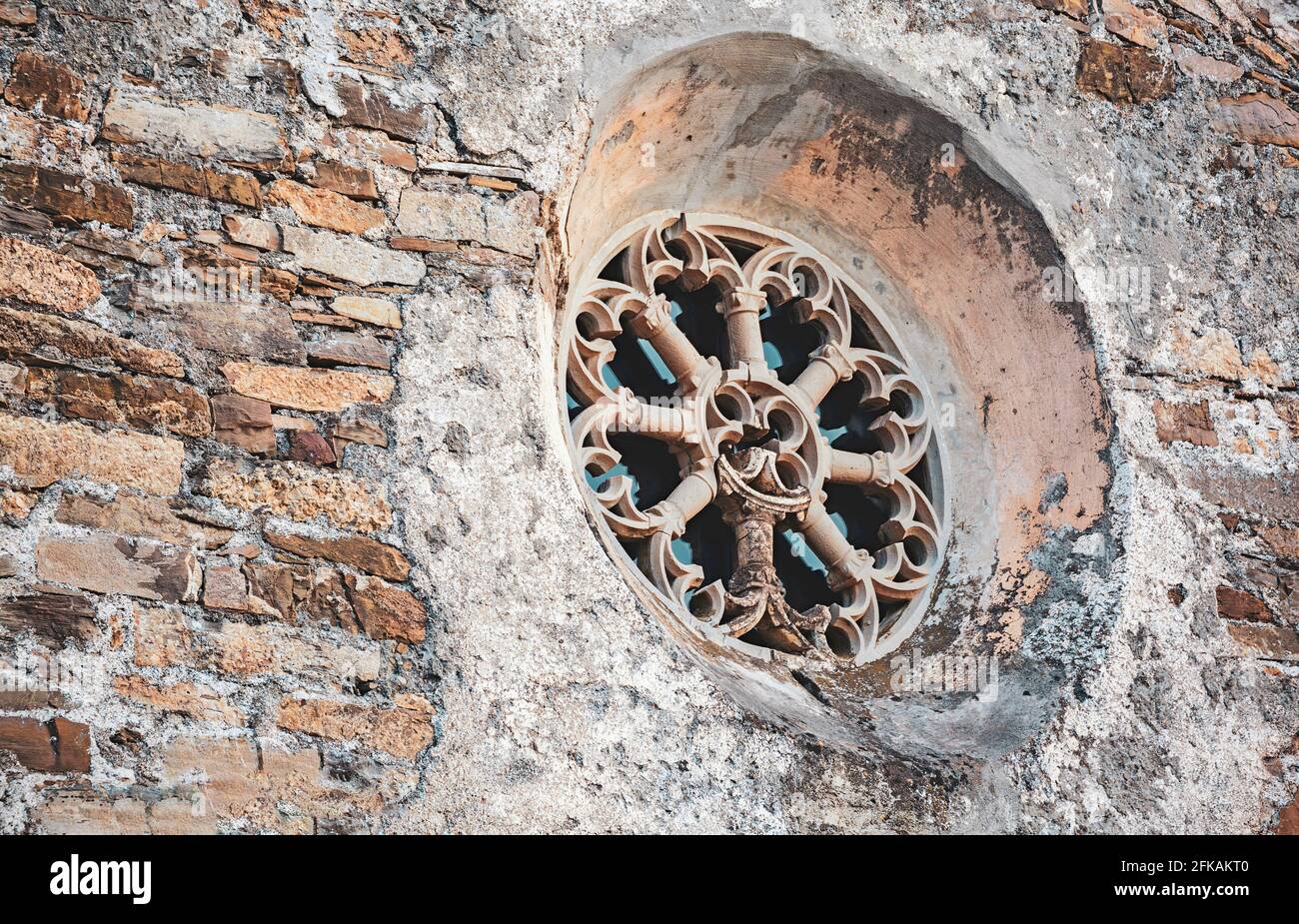ancient rose window of a church in the Ligurian hinterland in Italy ...