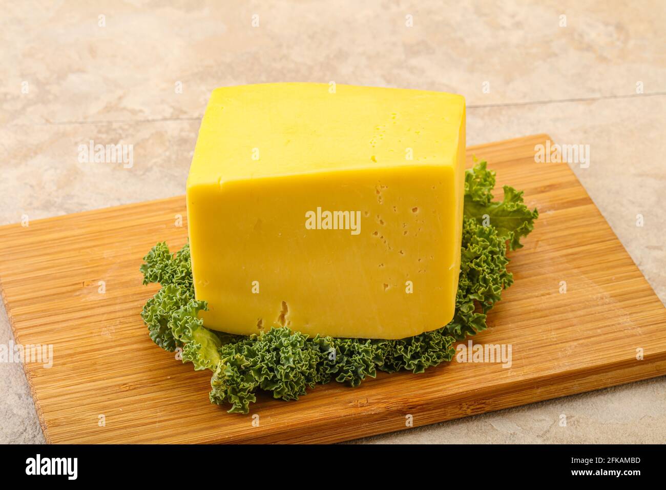 Yellow tilsiter cheese dairy product brick Stock Photo - Alamy